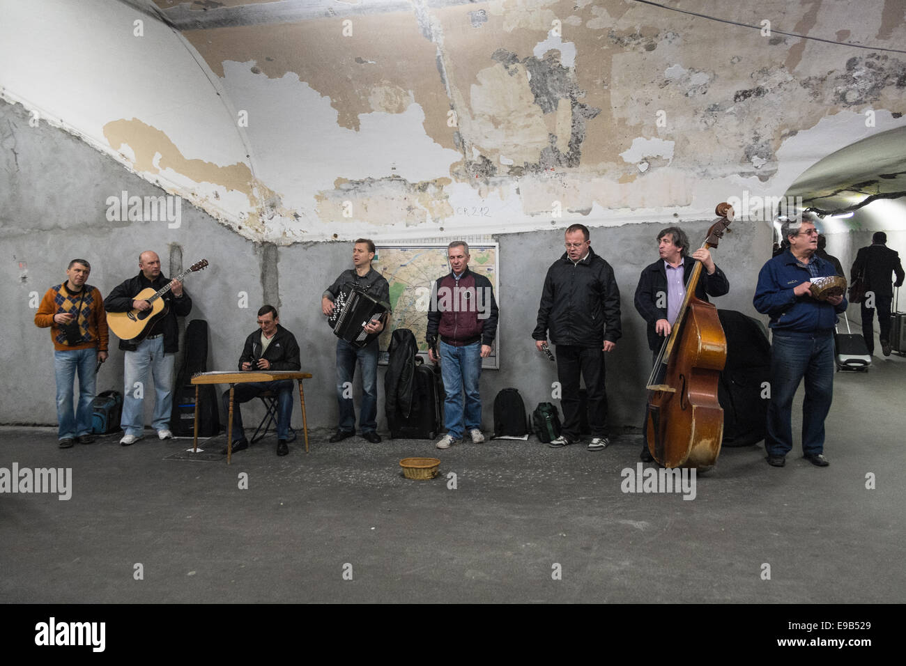 Large group of performers / buskers busking performing within train ...