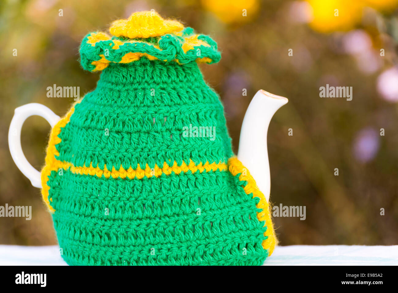 Knitted doily on the teapot on natural background Stock Photo - Alamy