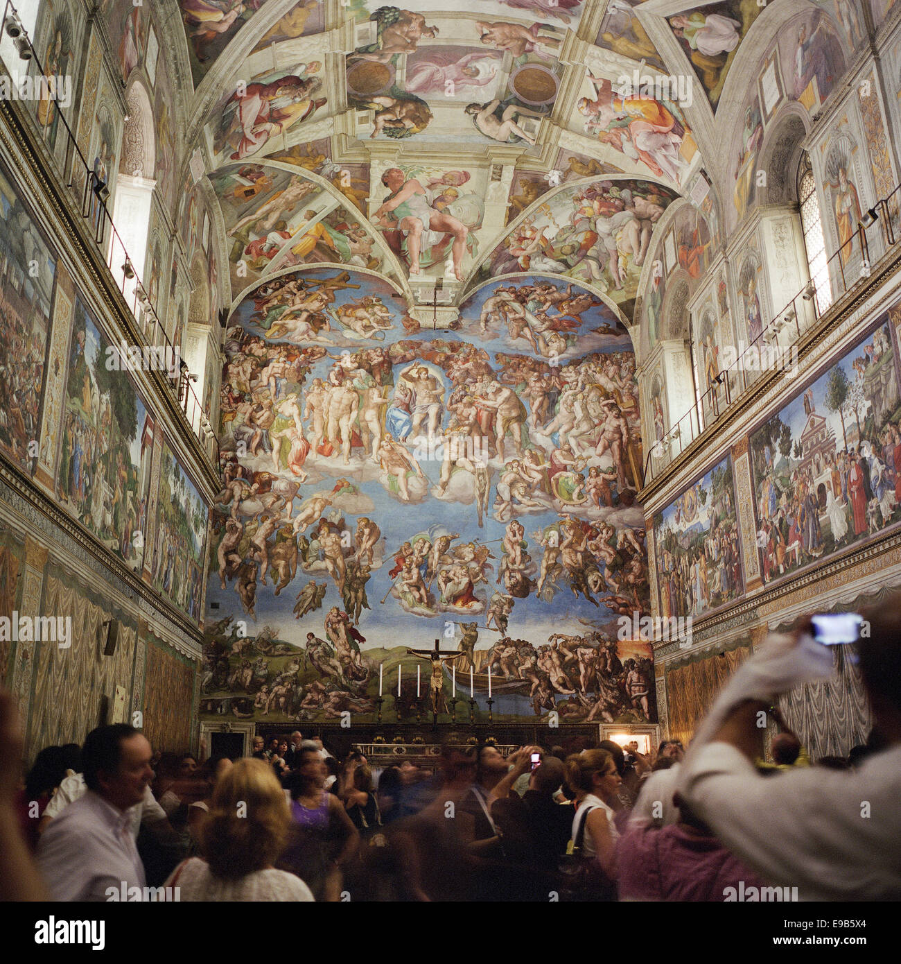 Rome. Italy. Tourists crowd the Sistine Chapel in the Vatican Museums ...