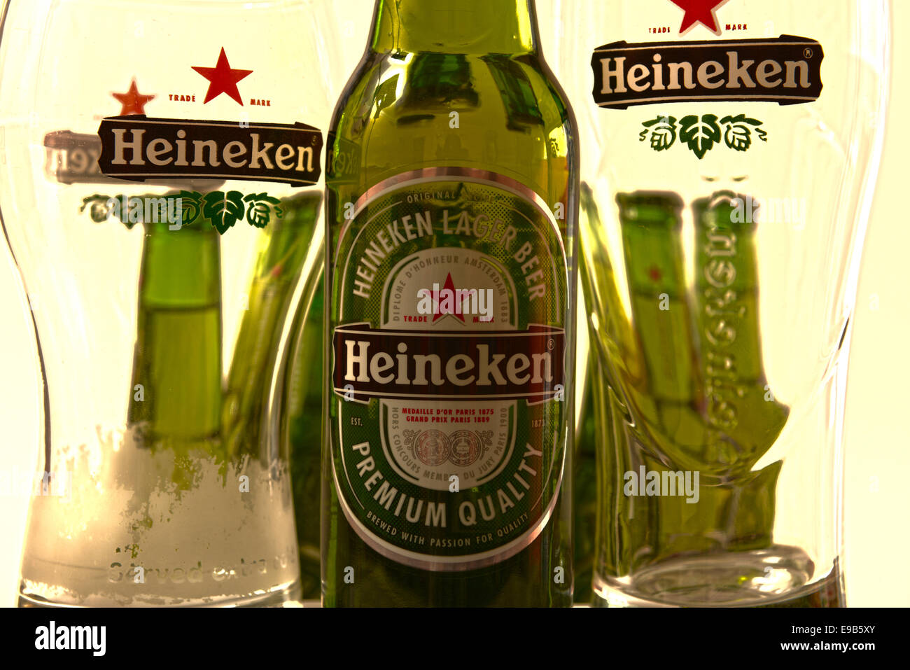 A row of Heineken Bottles with one bottle at the front next two pint ...