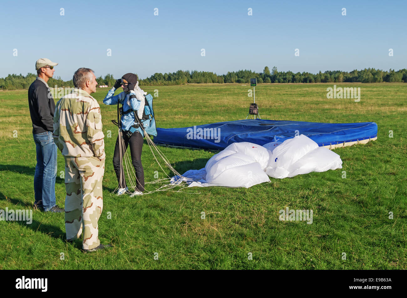 Parachutists - 2014. The girl skydiver after landing under white ...