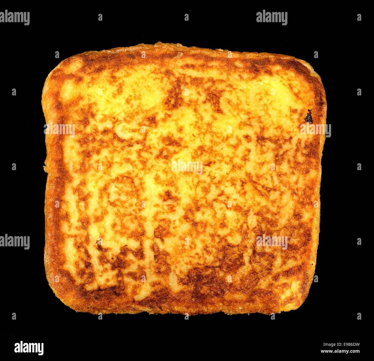 Slice of french toast on a black background Stock Photo - Alamy