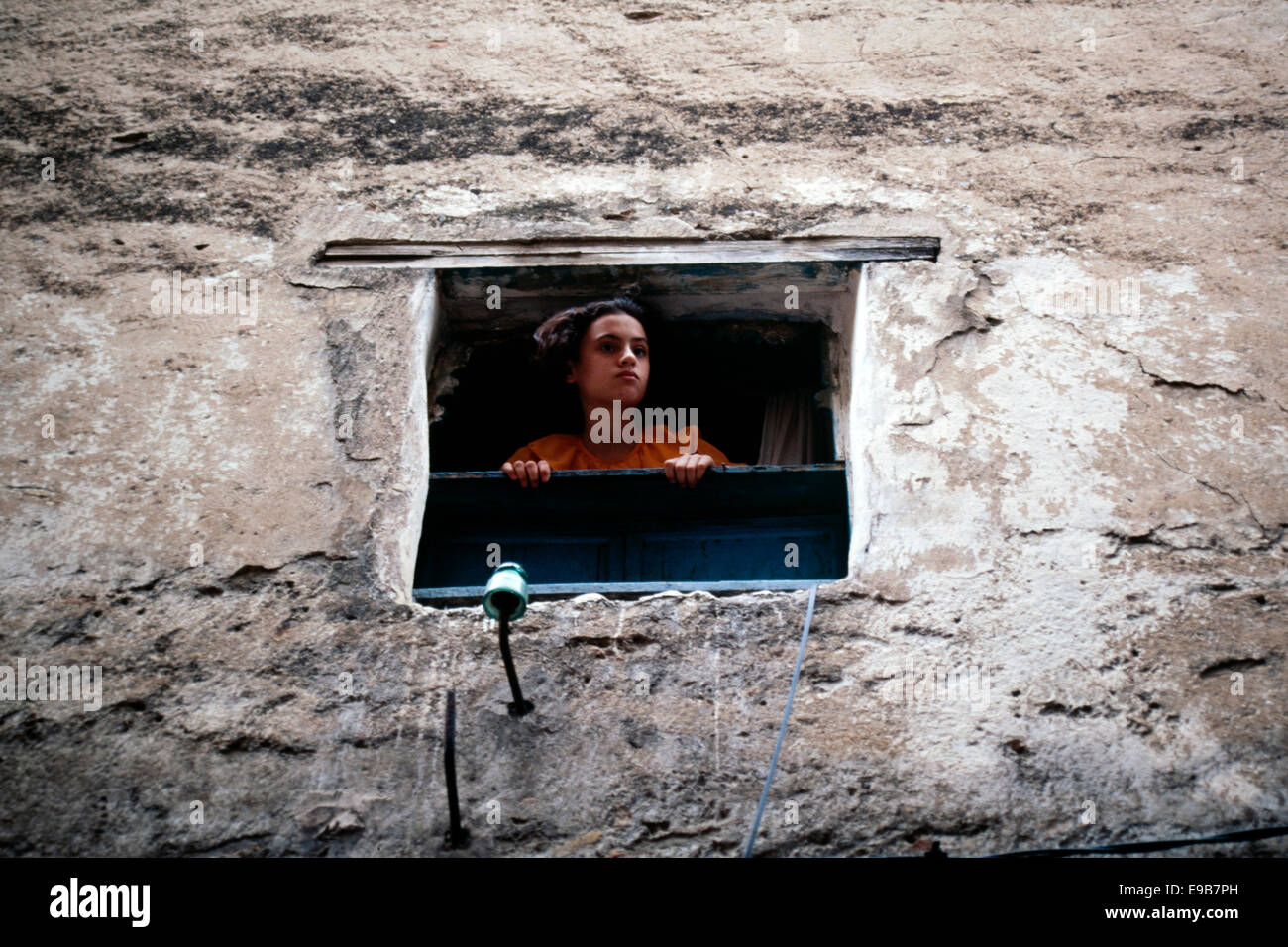young local woman looking out of barred window in fez morocco north ...