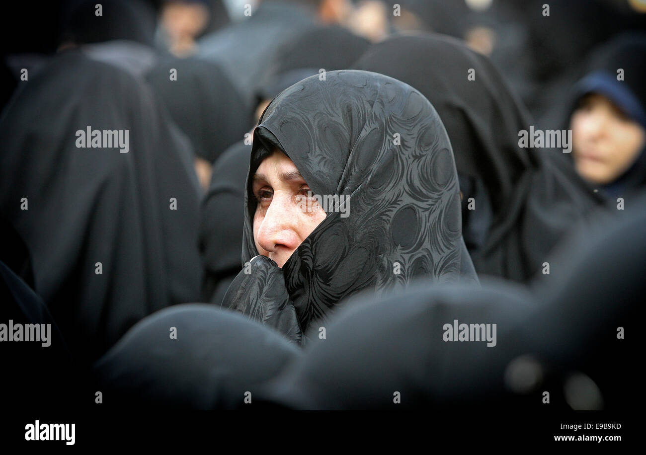 Tehran, Iran. 23rd Oct, 2014. A woman cries during a funeral ceremony ...
