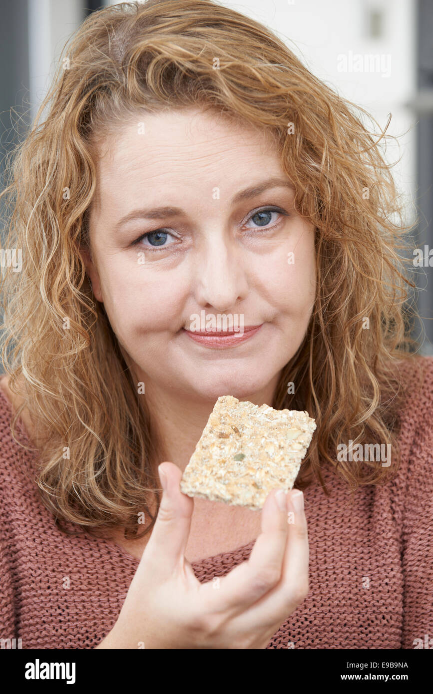 Bored Woman On Diet Eating Crispbread At Home Stock Photo - Alamy