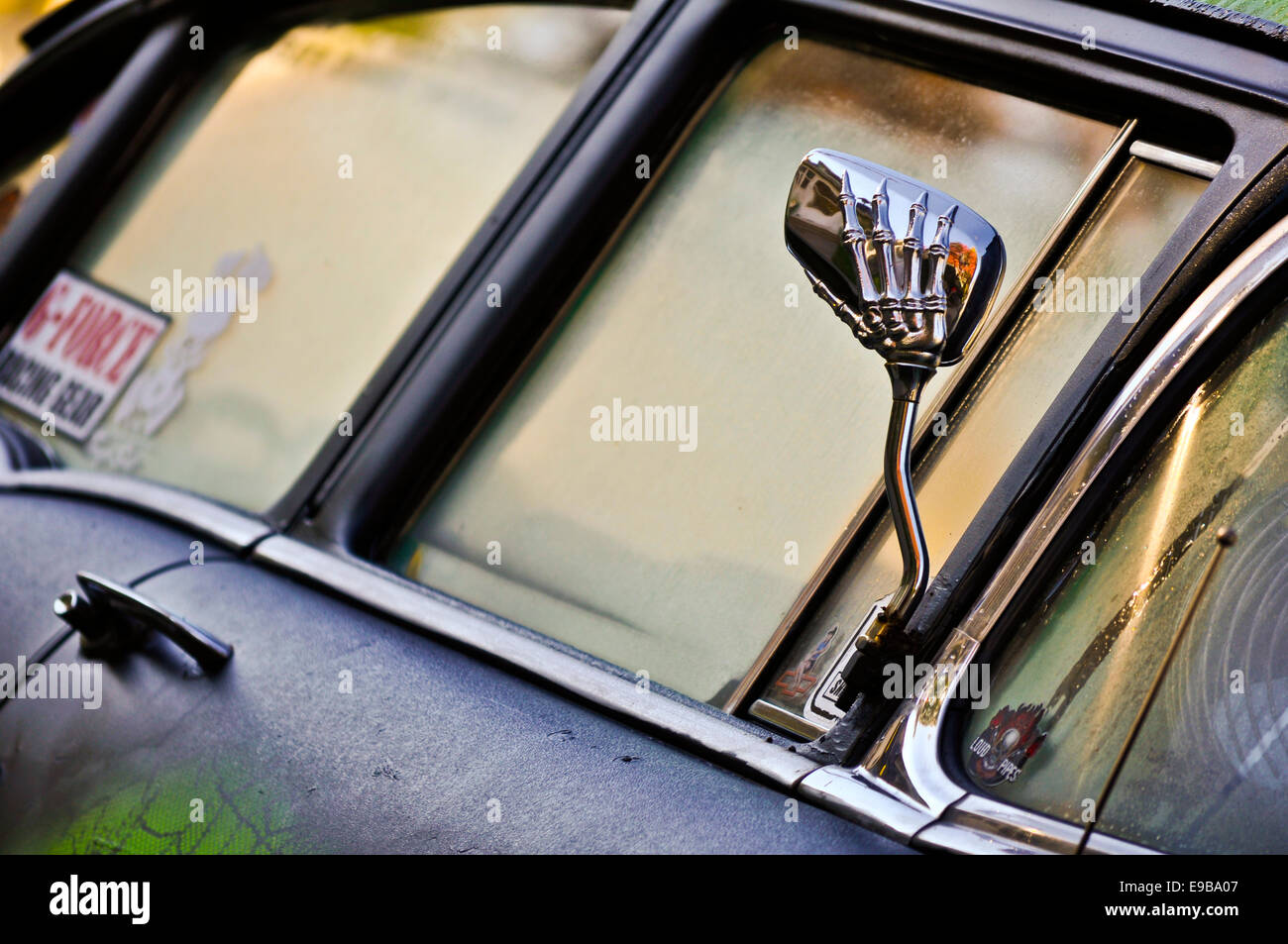 Up close car side view mirror in the shape of a skeleton hand, the car ...