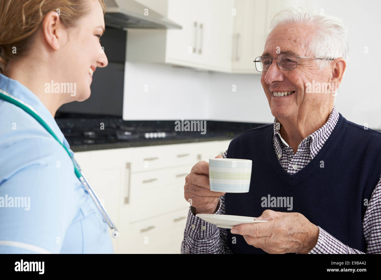 Nurse Chatting With Senior Man During Home Visit Stock Photo - Alamy