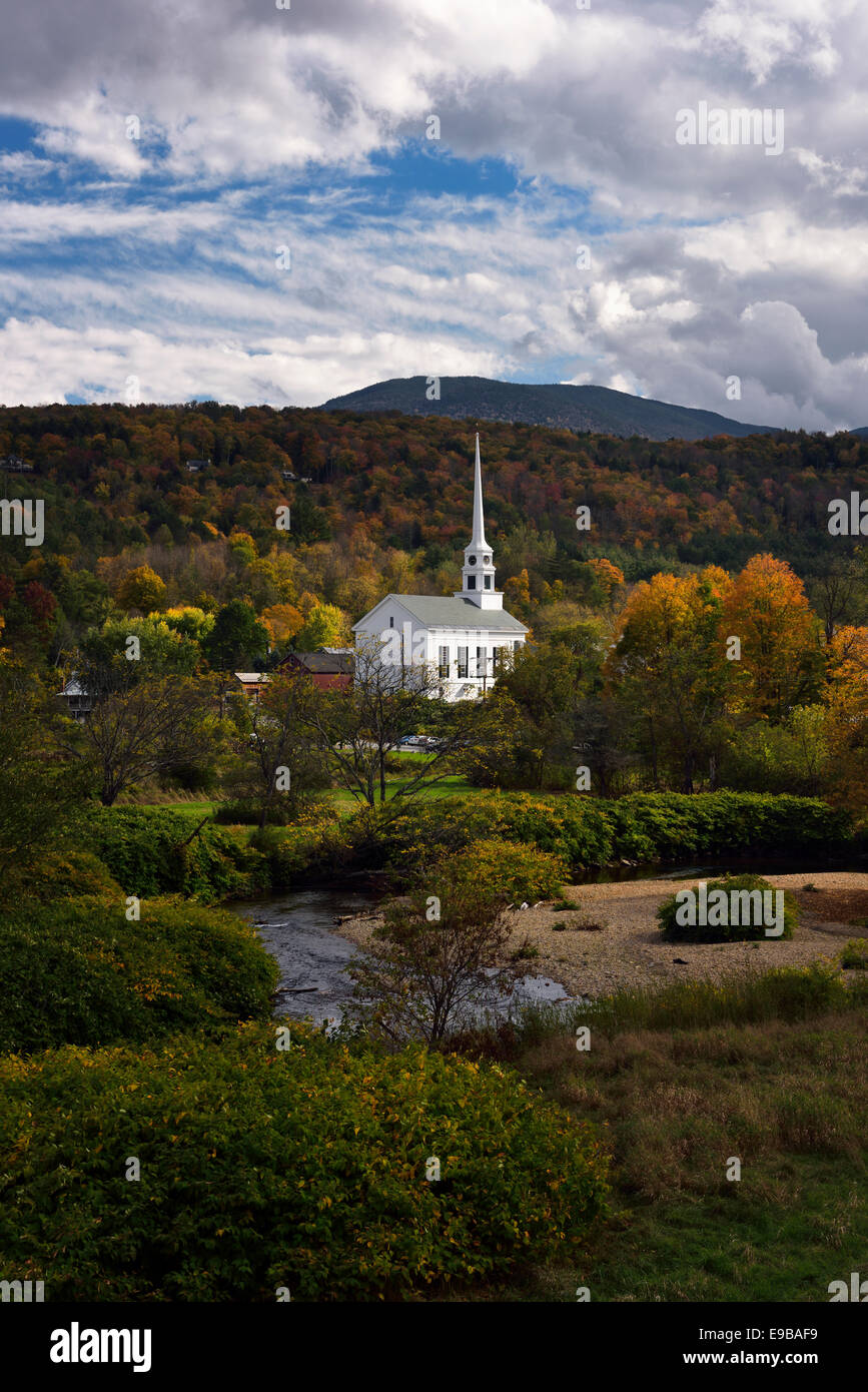 Spot of sun on Stowe Community Church on a cloudy day with Fall colors ...