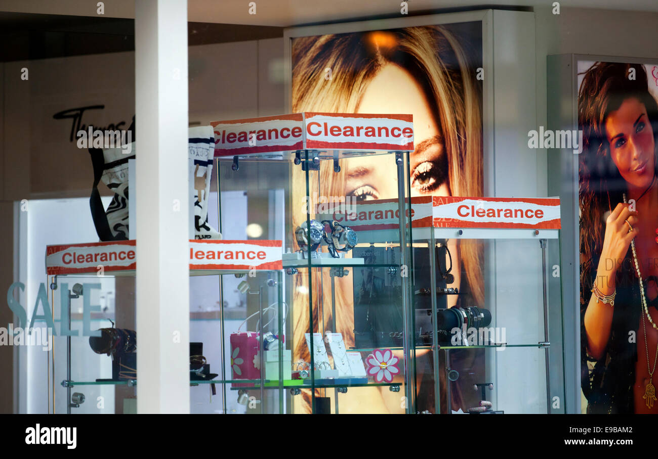 Discount clearance sale signs in camera equipment shop window display ...