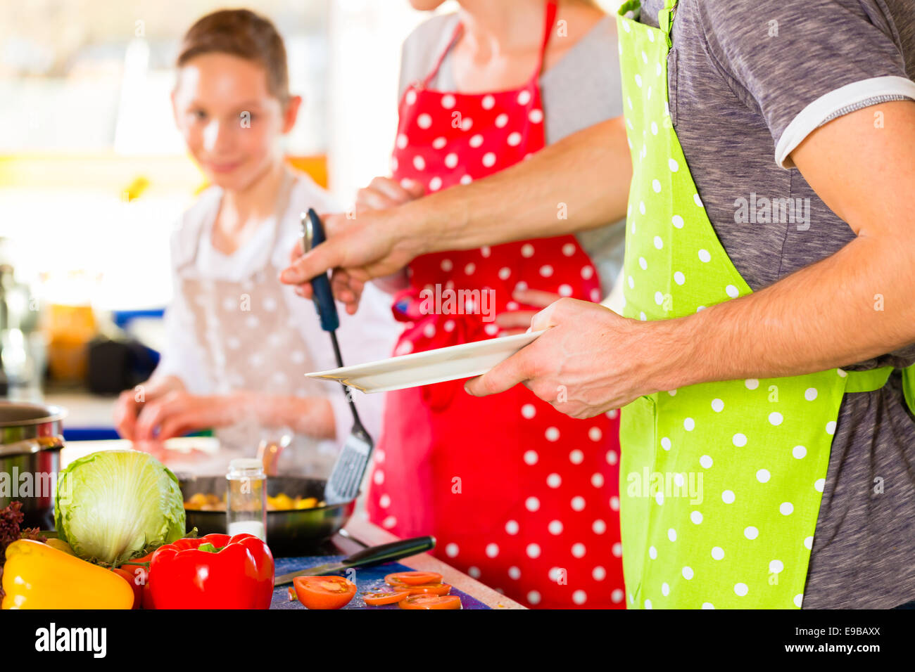Family with Parents and children preparing healthy meal in domestic ...
