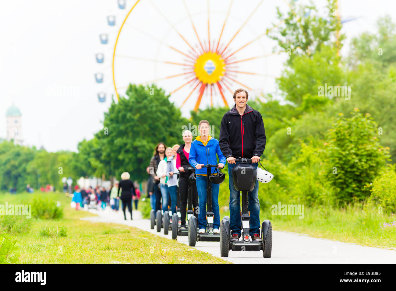 Tourist group having guided Segway theme park tour Stock Photo - Alamy