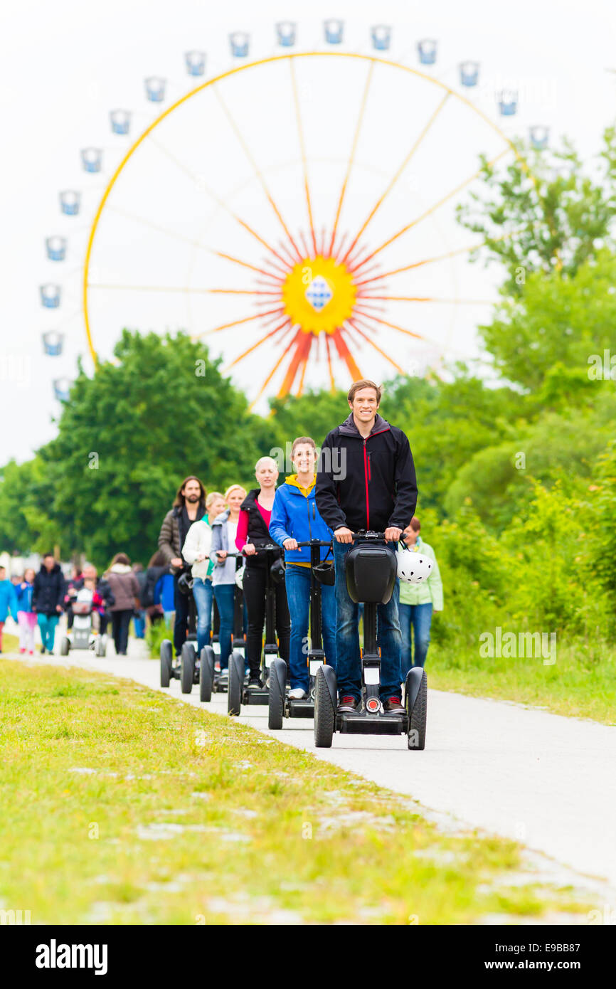 Tourist group having guided Segway theme park tour Stock Photo - Alamy