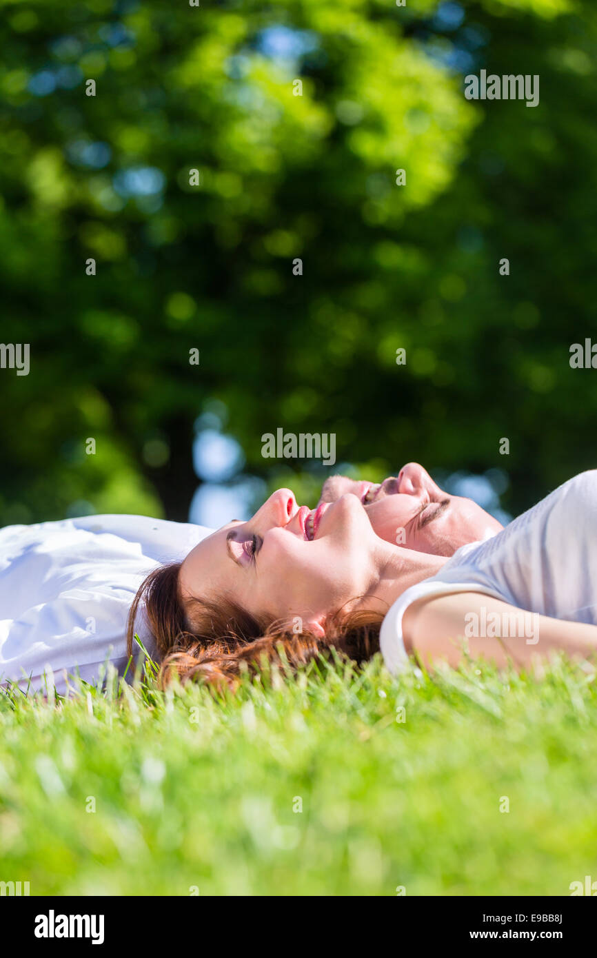 Young friends lounging on park hi-res stock photography and images - Alamy