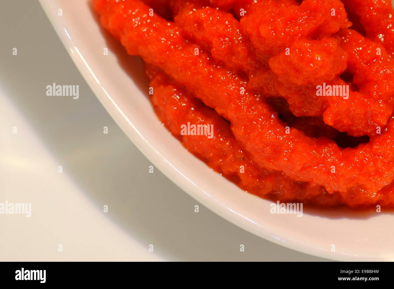Tomato puree in a spoon Stock Photo - Alamy