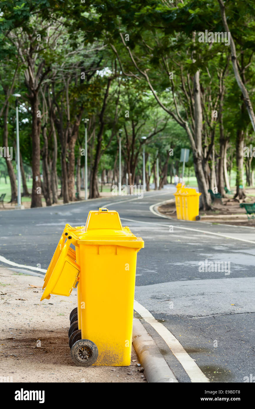 Yellow bin in park Stock Photo - Alamy