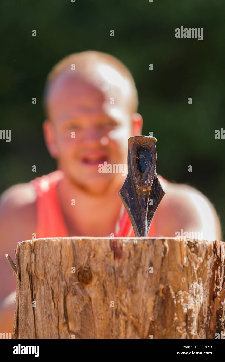 young man outdoors splitting wood by hand for the wirer Stock Photo - Alamy