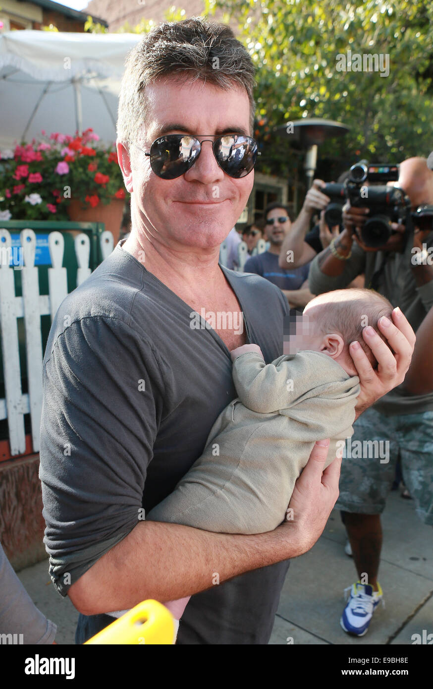 Simon Cowell Holding Baby