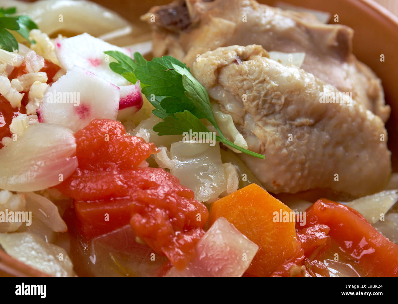 chicken posole garnished with carrots, tomato and radish Stock Photo ...