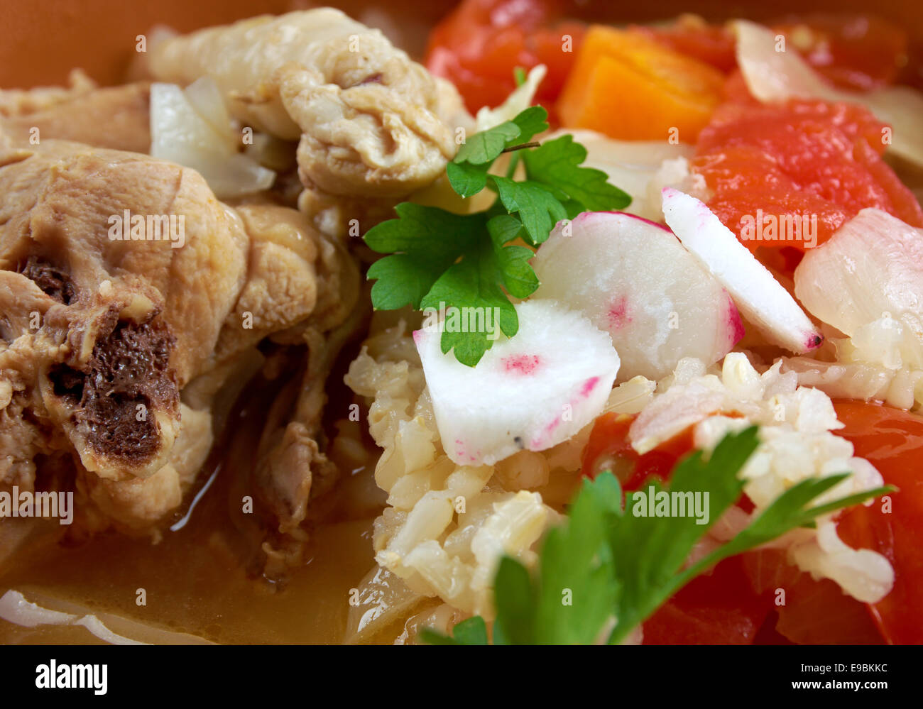 chicken posole garnished with carrots, tomato and radish Stock Photo ...
