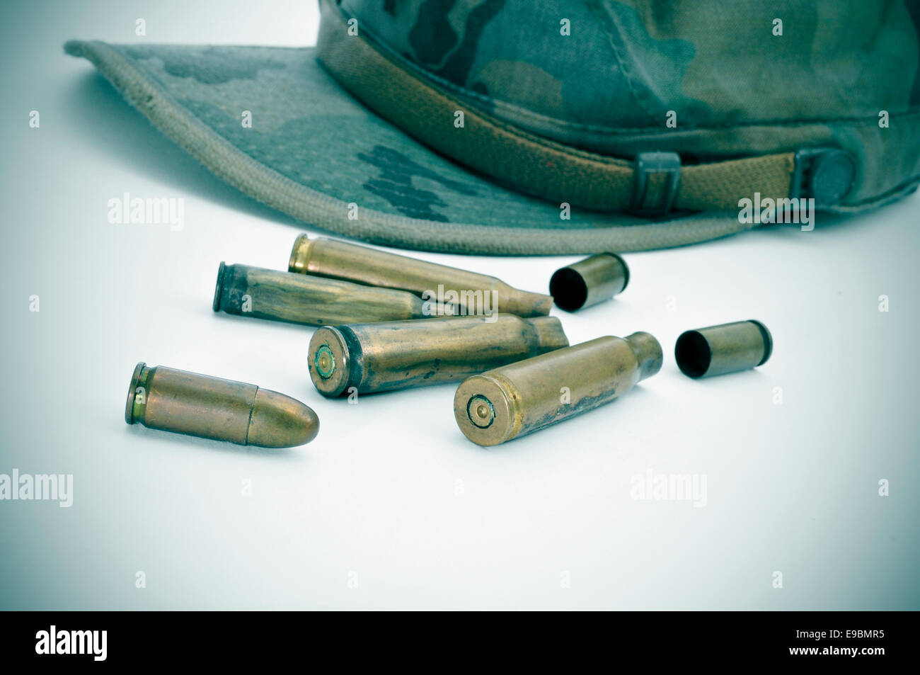 a camouflage cap and some bullets and bullet shells Stock Photo - Alamy
