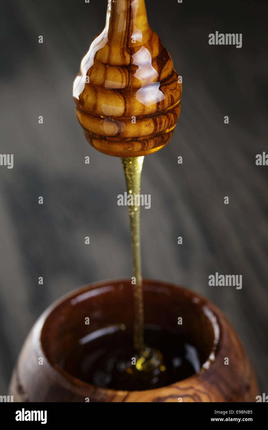 maple honey flowing from dipper to pot, vertical Stock Photo - Alamy