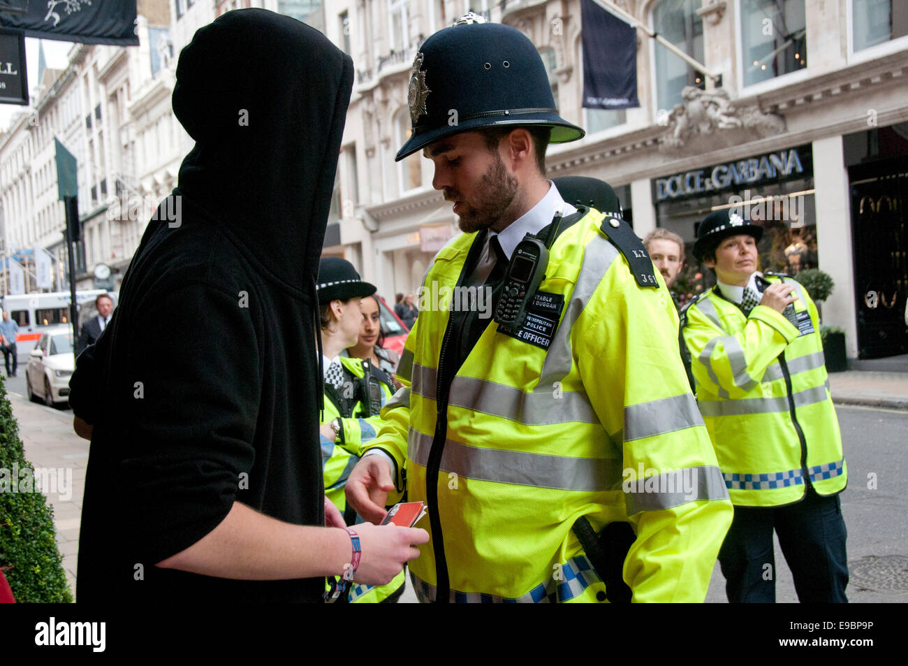 Police Officer stopping and searching youth with hoody in Bond Street ...