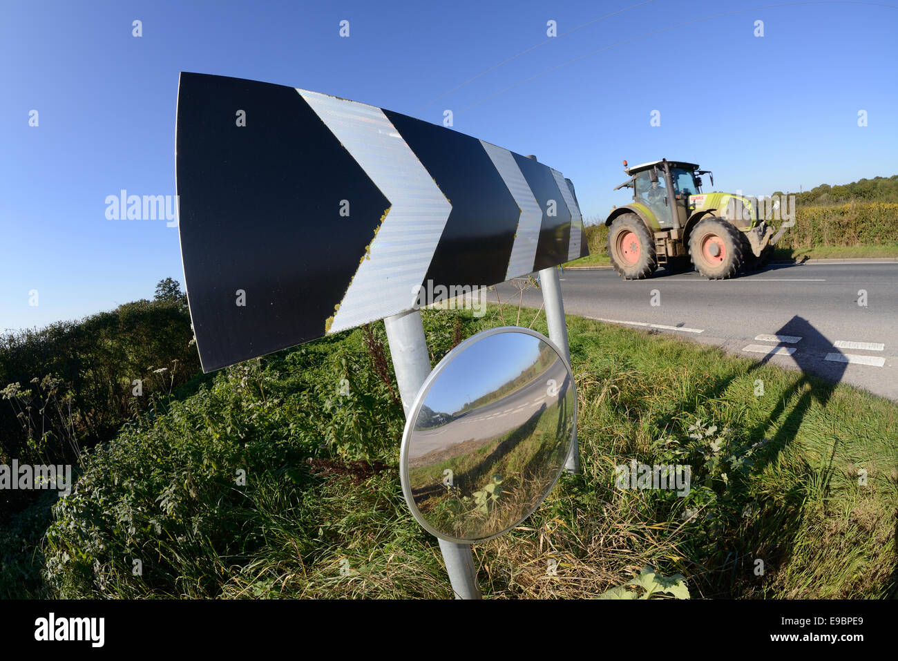 tractor passing warning sign of sharp bend and circular safety mirror ...