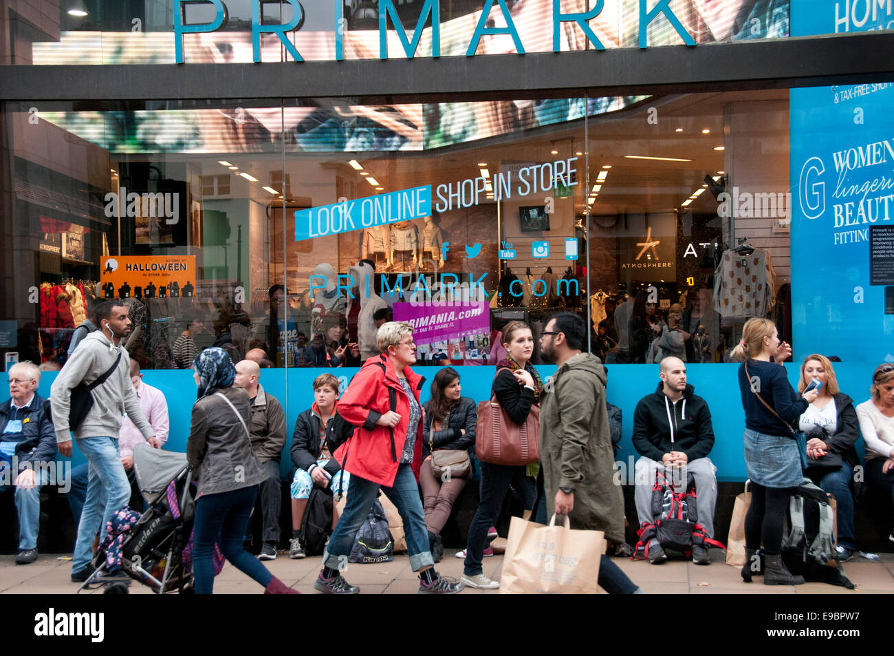 People sitting outside Primark Shop on Oxford Street London Stock Photo ...