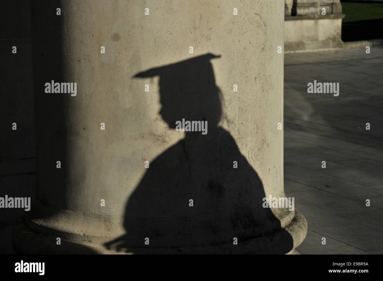 Shadow figures of graduates on graduation day dressed in gowns and ...