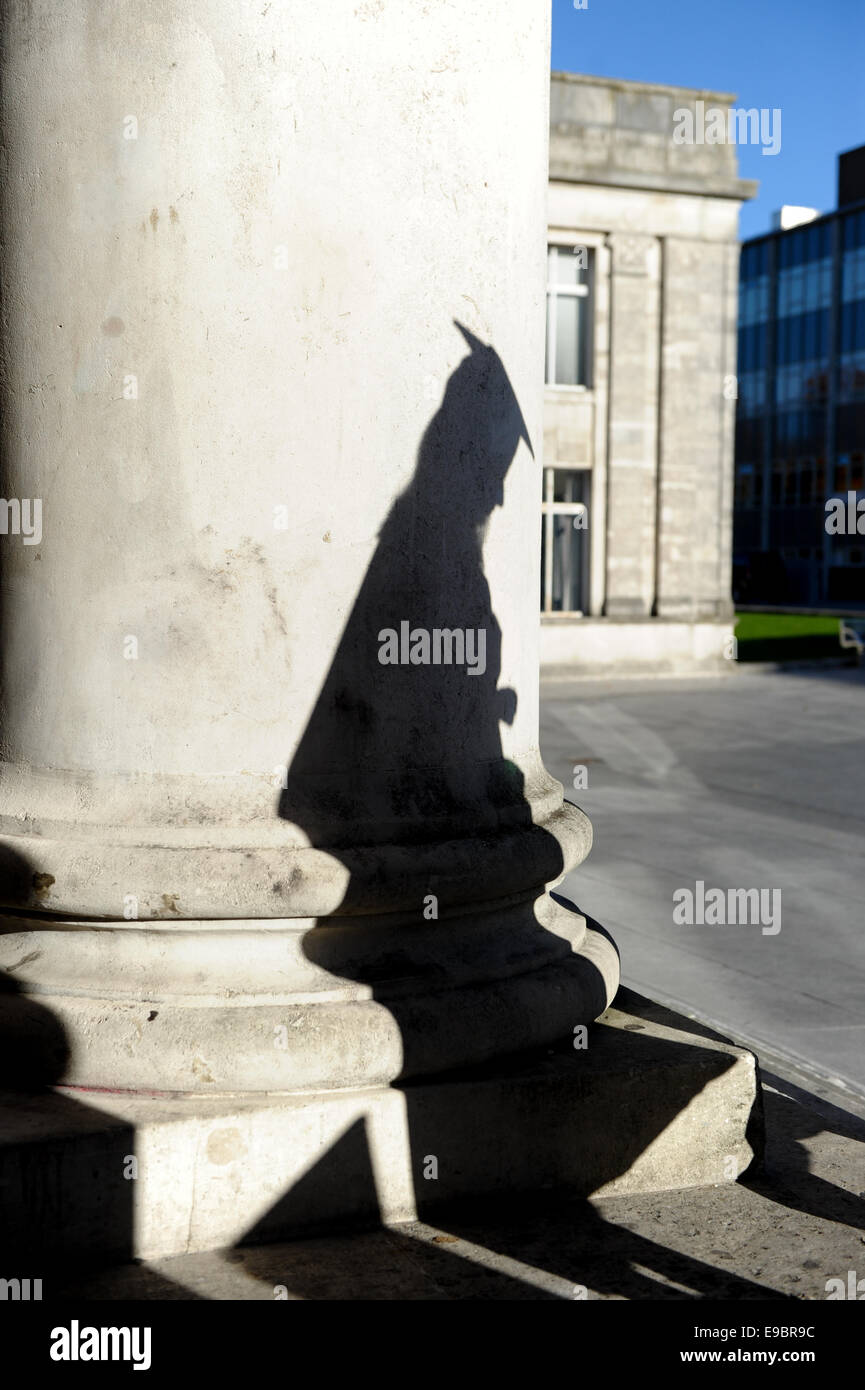 Shadow figures of graduates on graduation day dressed in gowns and ...