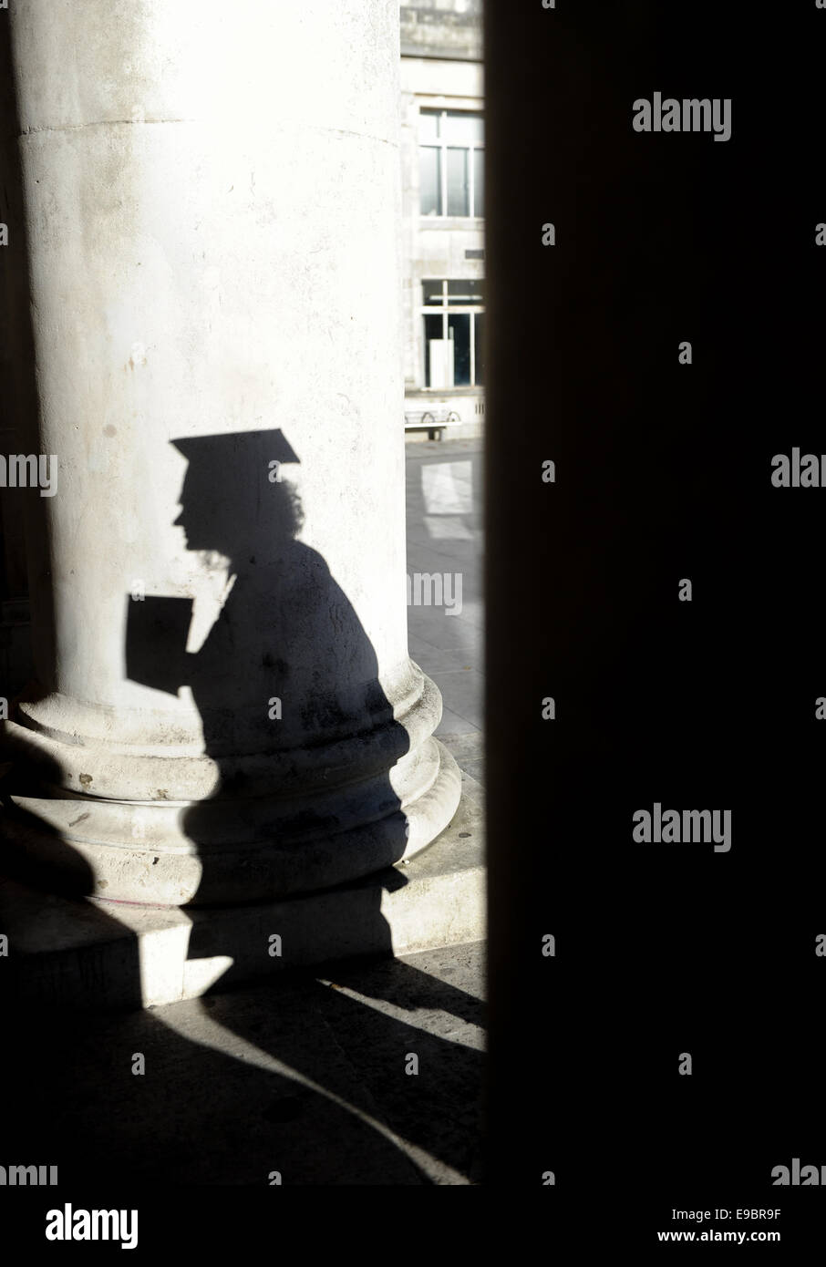 Shadow figures of graduates on graduation day dressed in gowns and ...