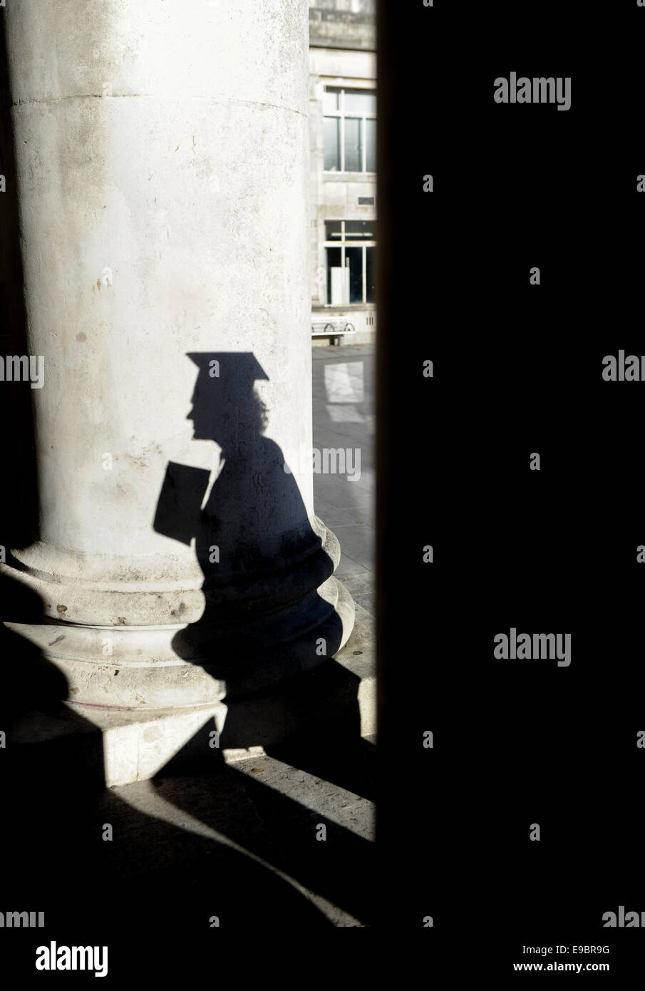 Shadow figures of graduates on graduation day dressed in gowns and ...