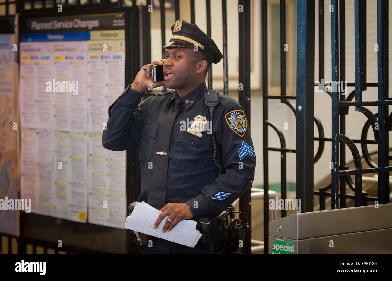 Manhattan, New York, USA. 23rd Oct, 2014. An officer on the phone in ...