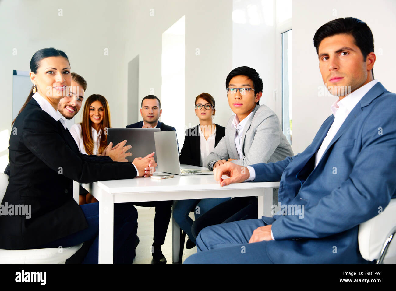 Businesspeople sitting at the table on a meeting Stock Photo - Alamy