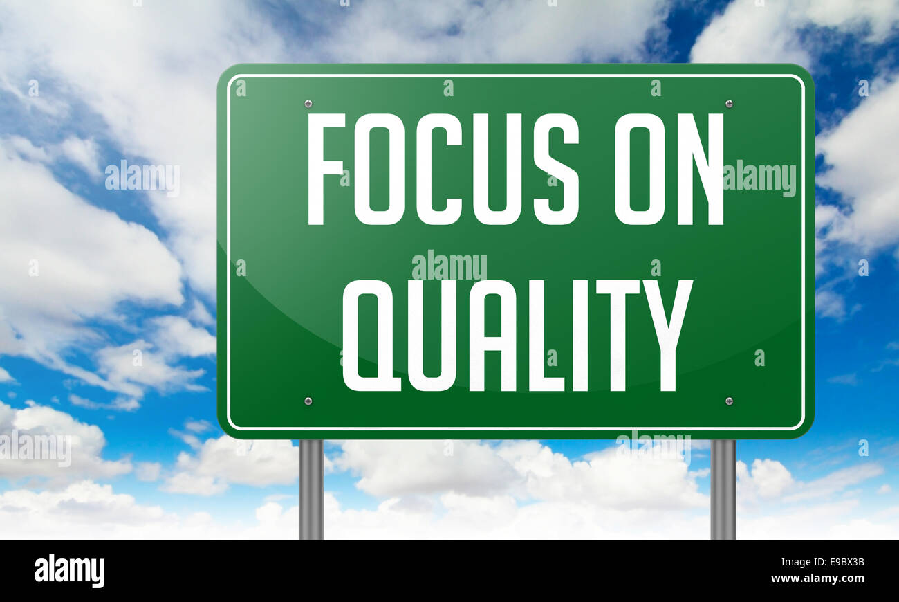 Focus on Quality in Green Highway Signpost Stock Photo - Alamy