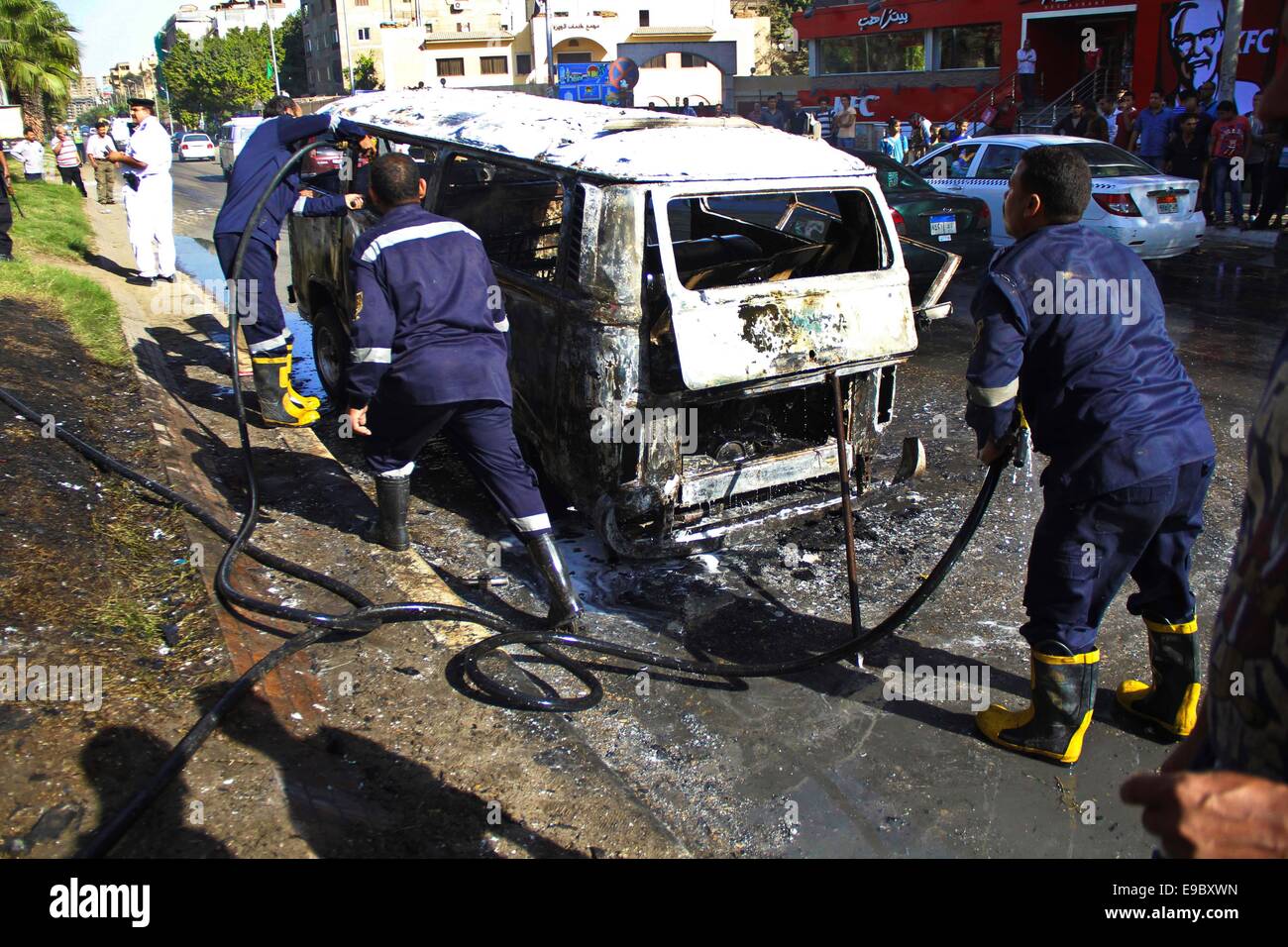 Cairo, Egypt. 24th Oct, 2014. Egyptian workers try to extinguish the ...