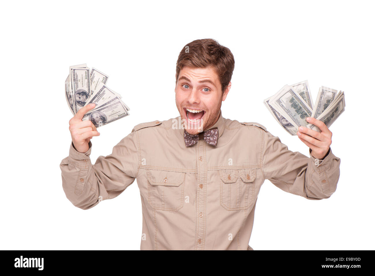 Cheerful young man with soft money Stock Photo - Alamy