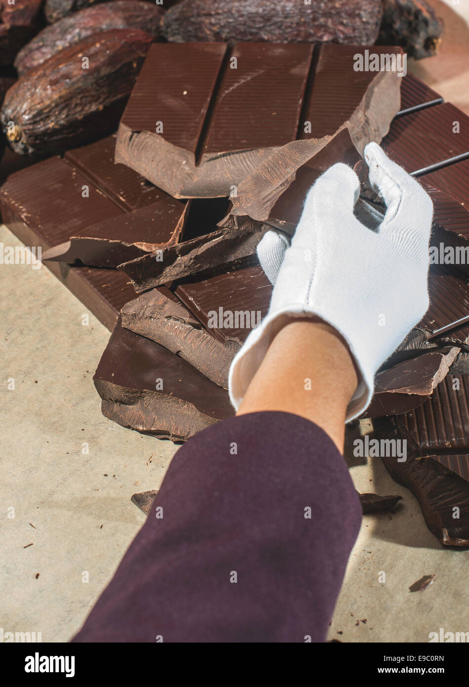 Hand holding chocolate bar crushed. Dark chocolate Stock Photo - Alamy