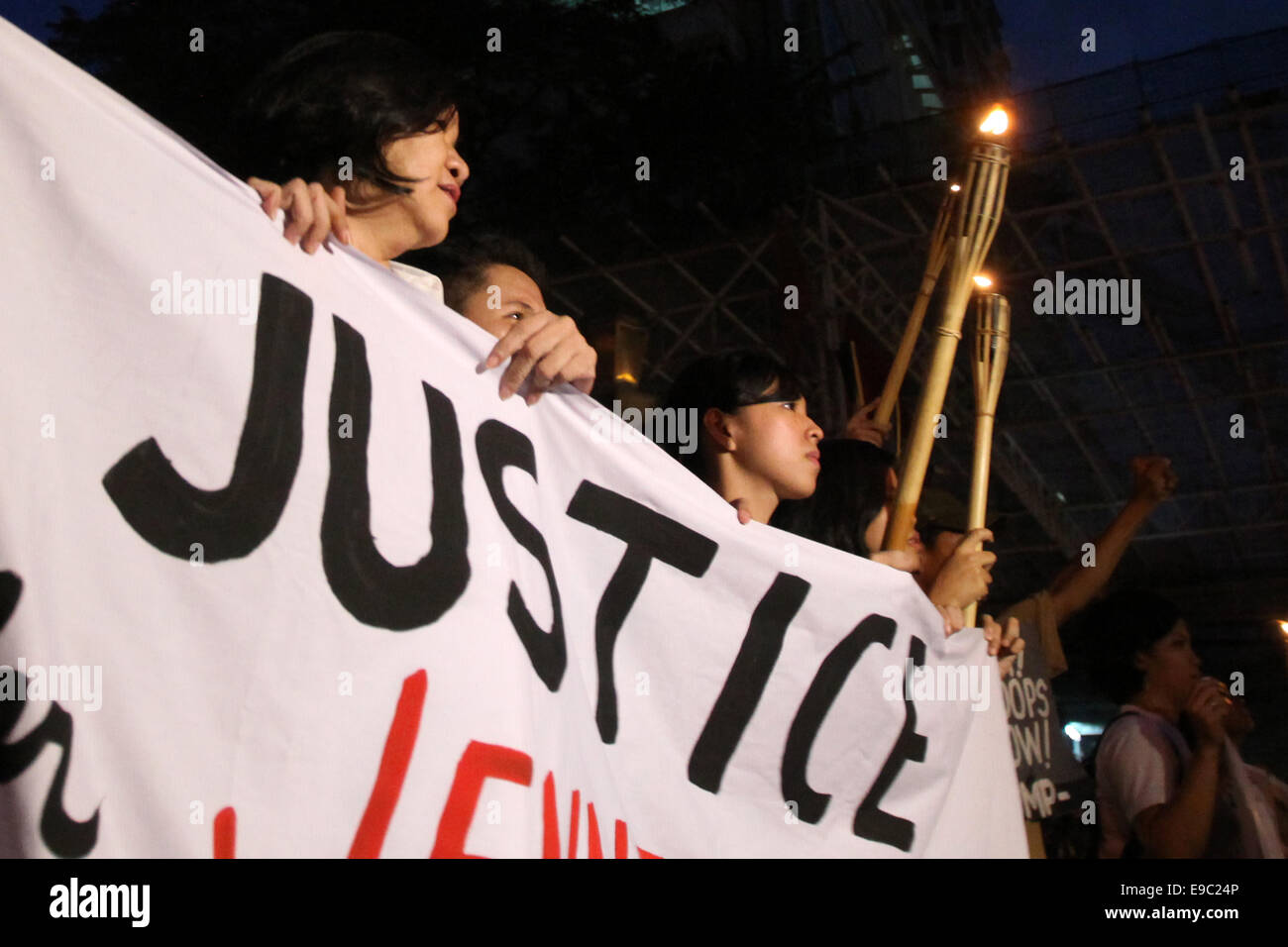 Manila, Phillipines. 24th October, 2014. Activists hold torches as they ...
