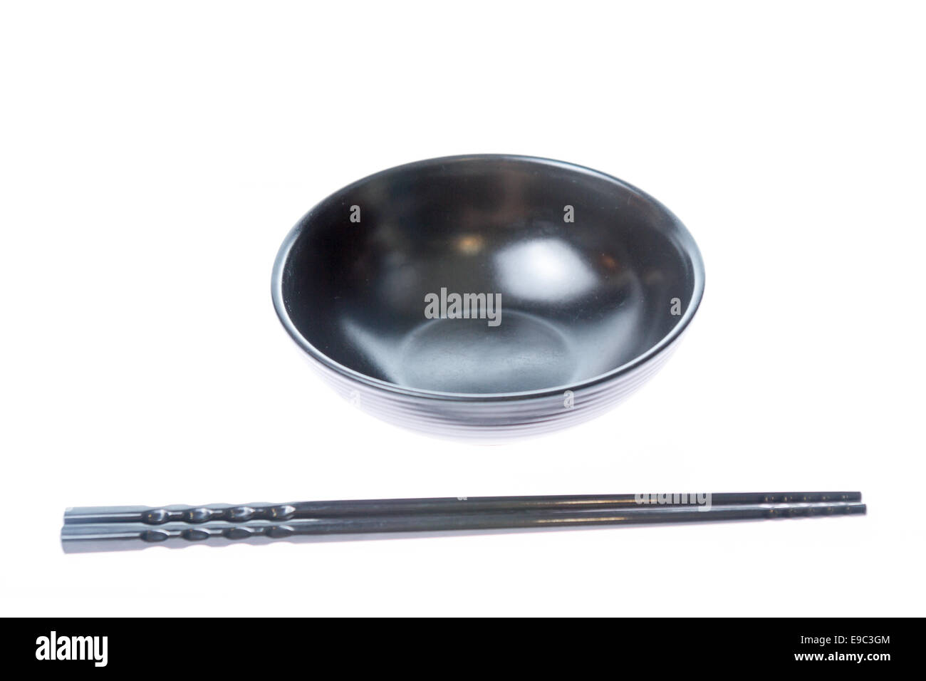 Chinese or Japanese chopsticks on empty black bowl Stock Photo - Alamy