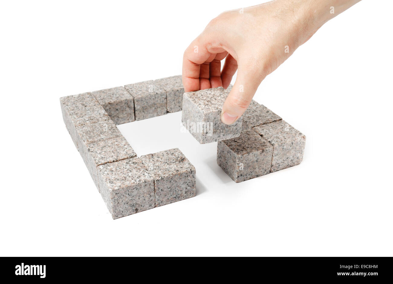 Man finishing a square made of small blocks of granite rock Stock Photo ...