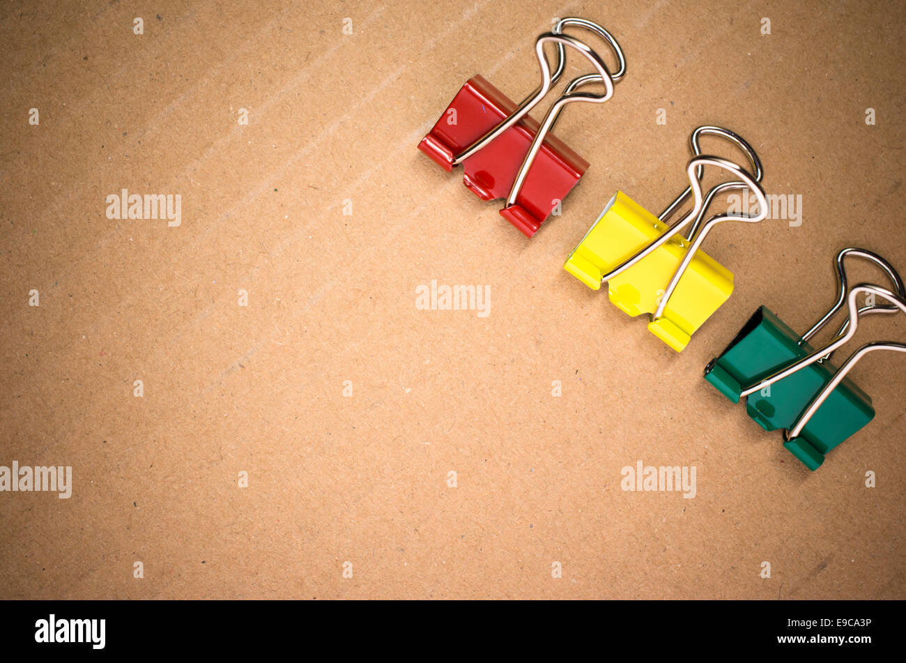 colored metal paper clips on a paperboard surface Stock Photo - Alamy