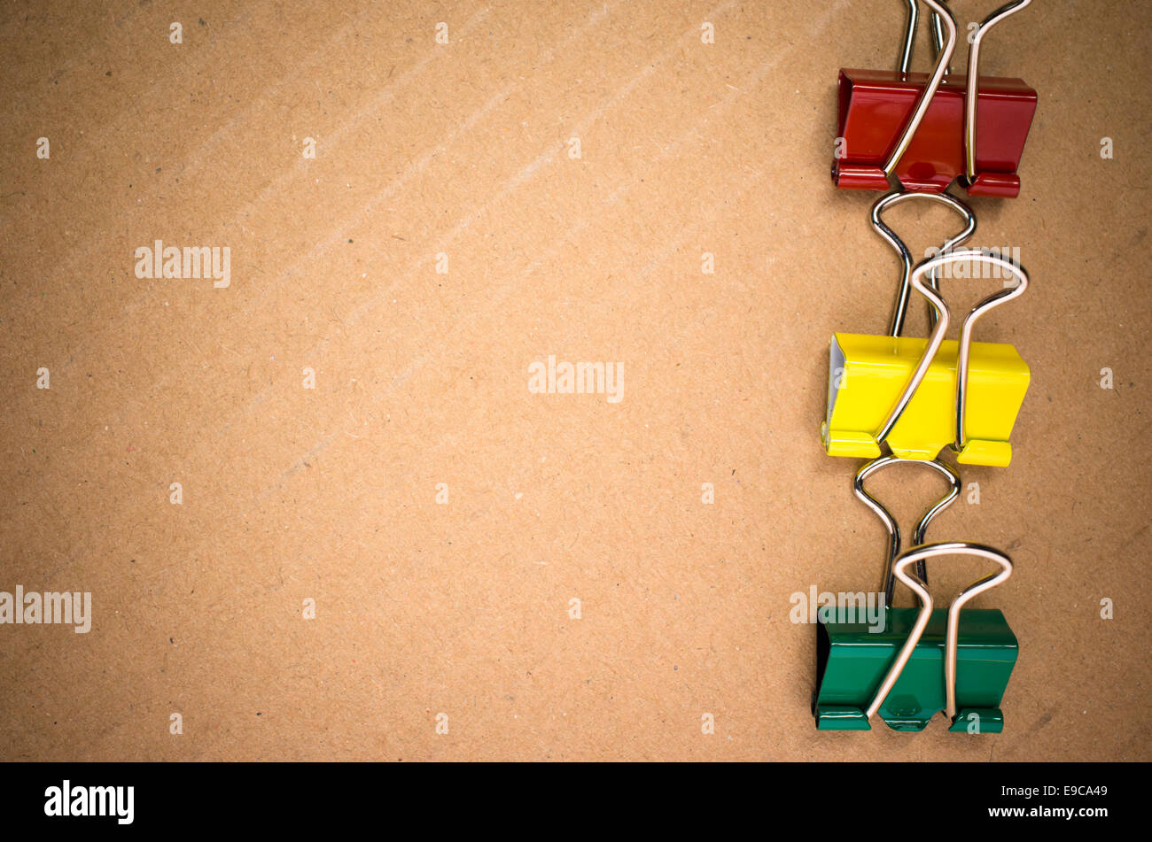 colored metal paper clips on a paperboard surface Stock Photo - Alamy