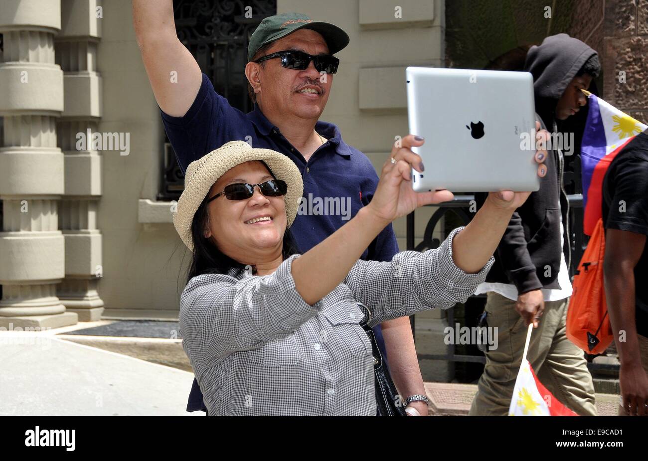NYC: Woman using an Apple ipad to take photos at the 2012 Philippines ...