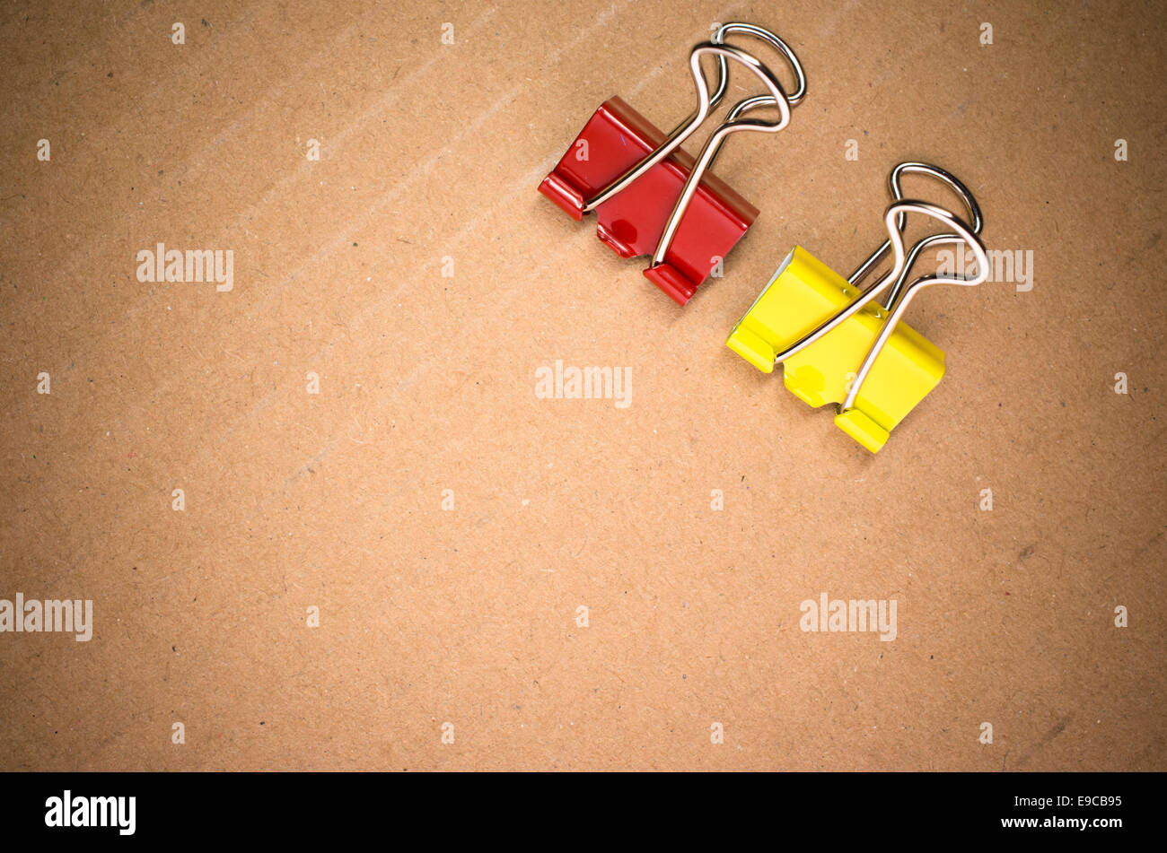 colored metal paper clips on a paperboard surface Stock Photo - Alamy