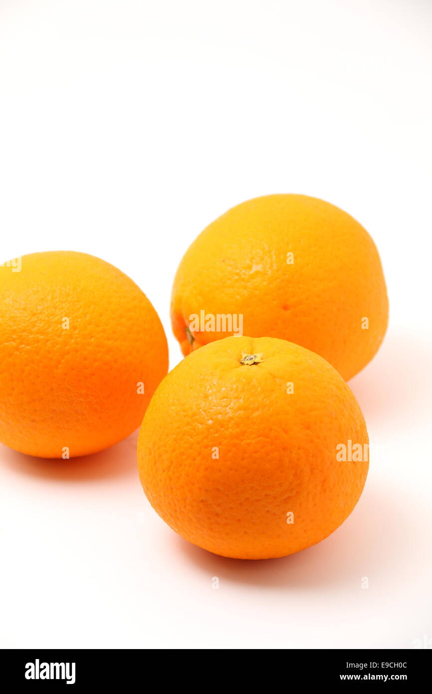 A three orange in isolated white background Stock Photo - Alamy