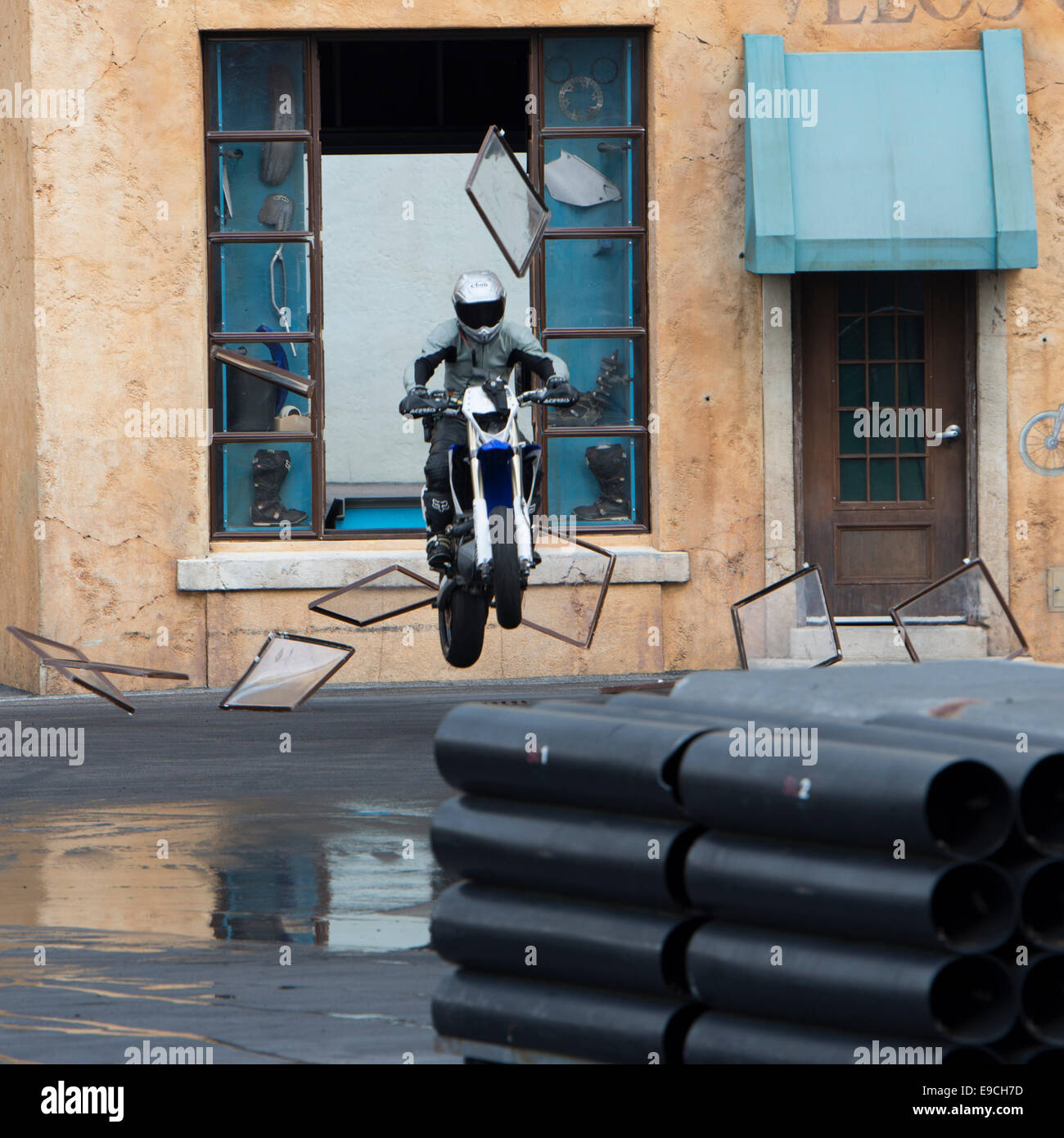 Motorcyle rider breaks through window, panes flying, during the Lights ...