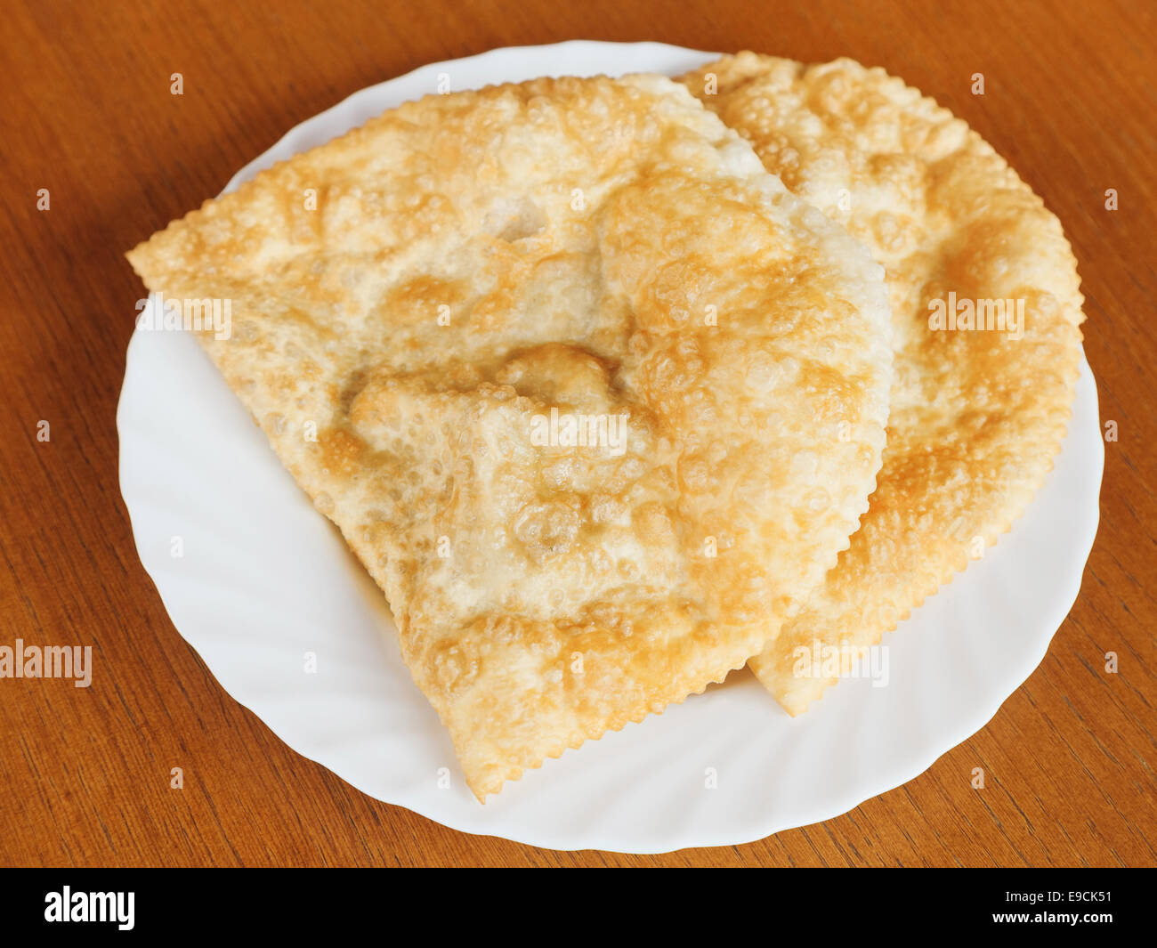 Crimean tatar cuisine - top view of cheburek pie on white plate Stock ...