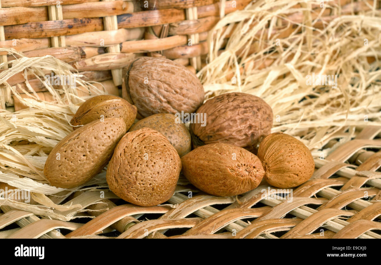Different nuts in village basket closeup Stock Photo - Alamy