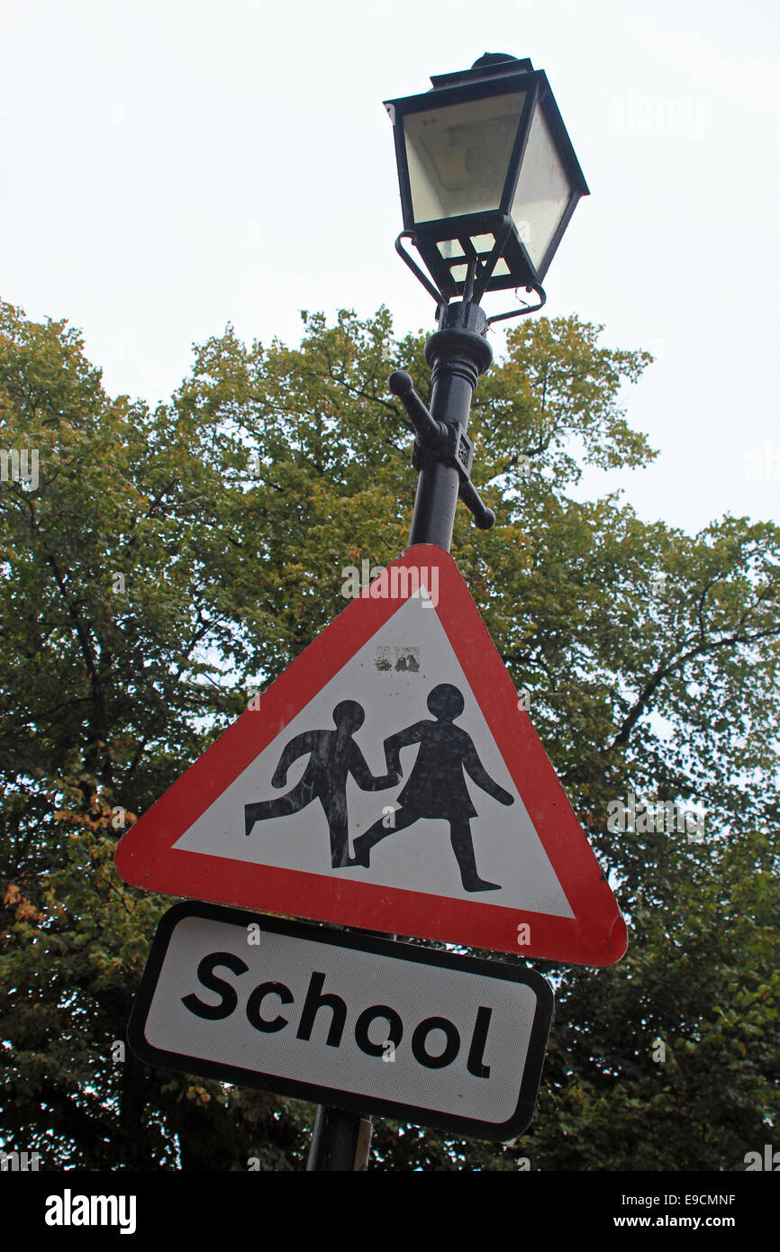 Close-up of a sign for a school on a lamp post Stock Photo - Alamy